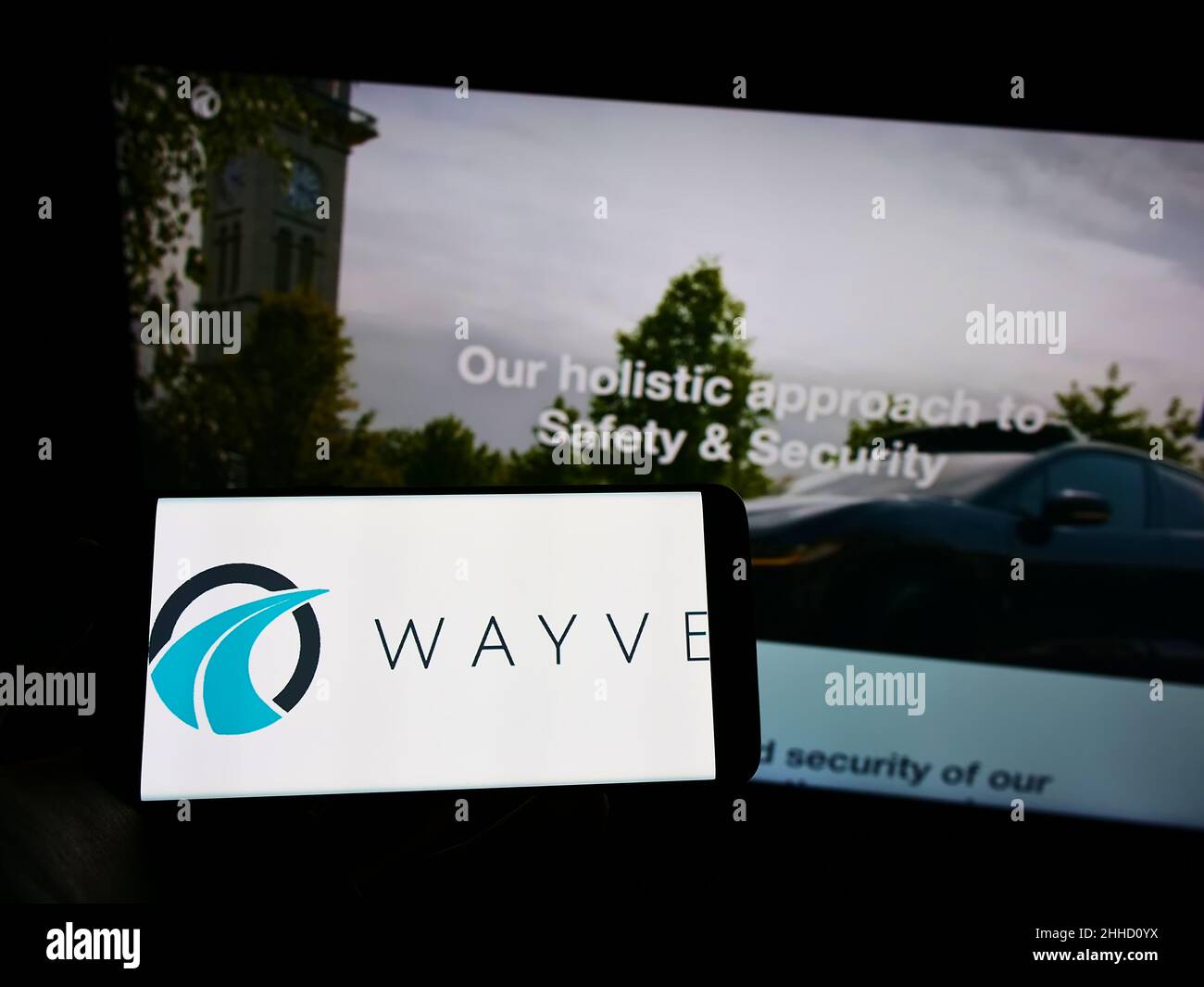 Person holding mobile phone with logo of British company Wayve ...