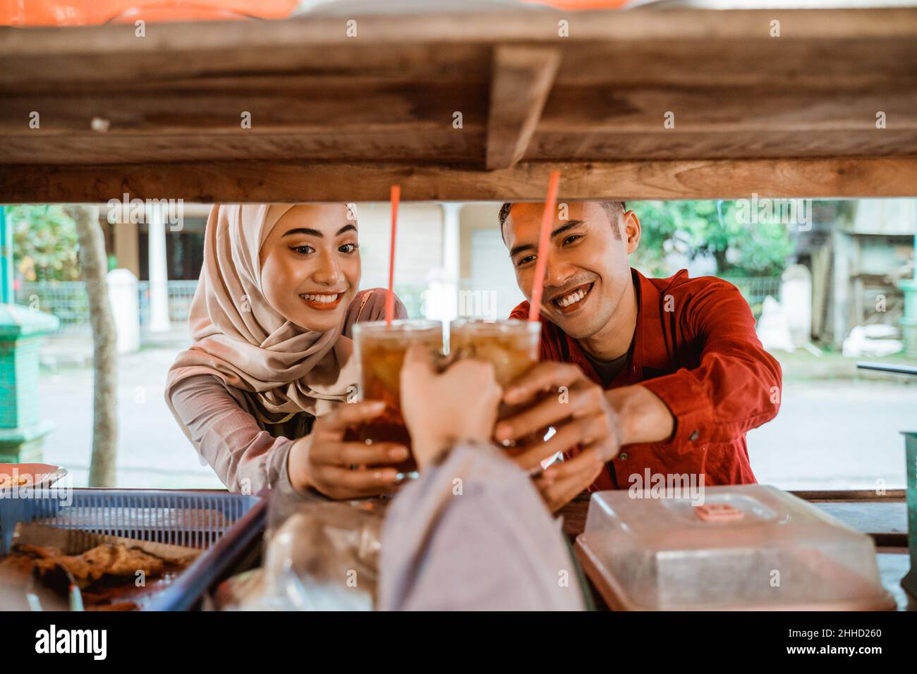 muslim couple sitting on traditional food stall, waiting for iftar time ...