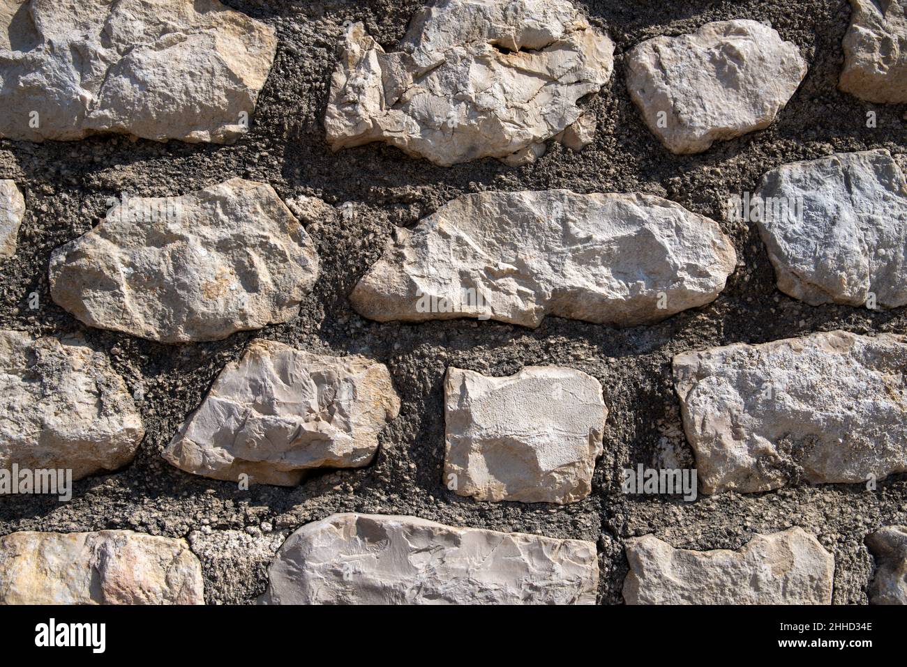 Wall made of mortar and natural stones as background or texture Stock ...