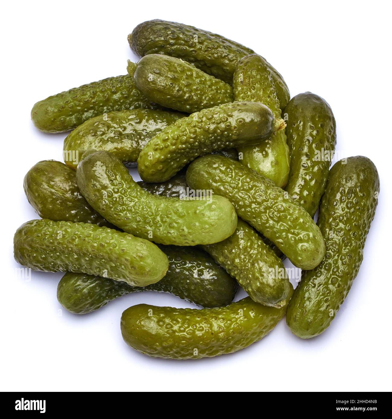 Pile of of Tasty canned Whole green cornichons isolated on a white ...