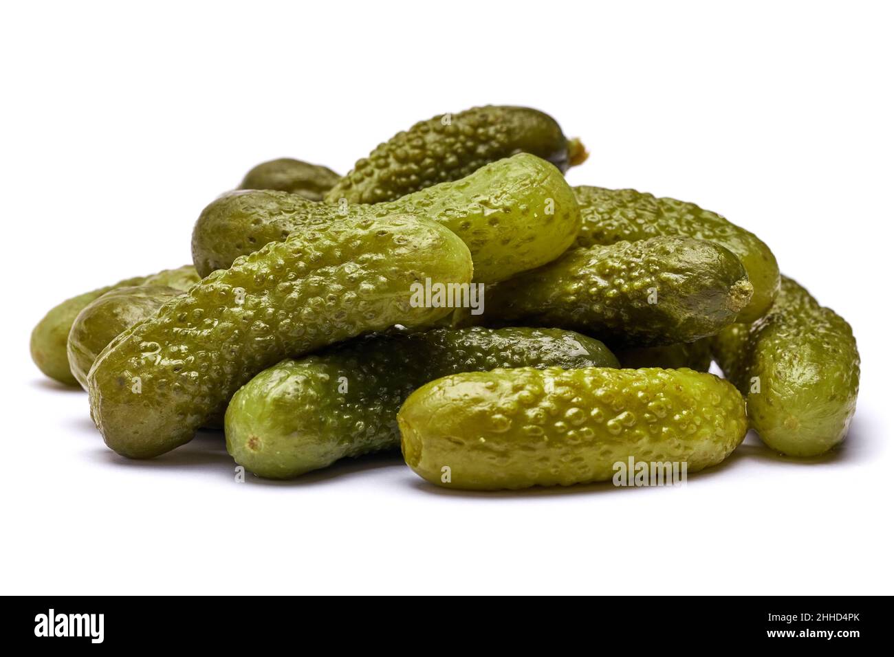 Pile of of Tasty canned Whole green cornichons isolated on a white ...