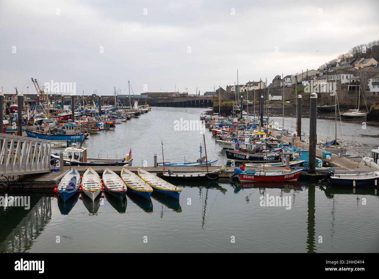Longboats and Fishing boats moored in Newlyn Harbour, Cornwall,UK Stock ...