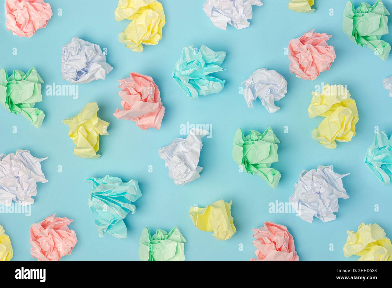 Pattern made with colored crumpled paper balls on blue background ...