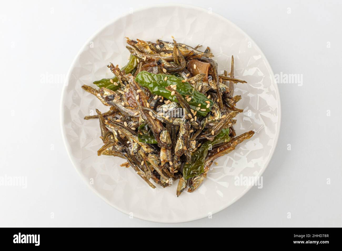 Stir-fried anchovies on white background Stock Photo - Alamy