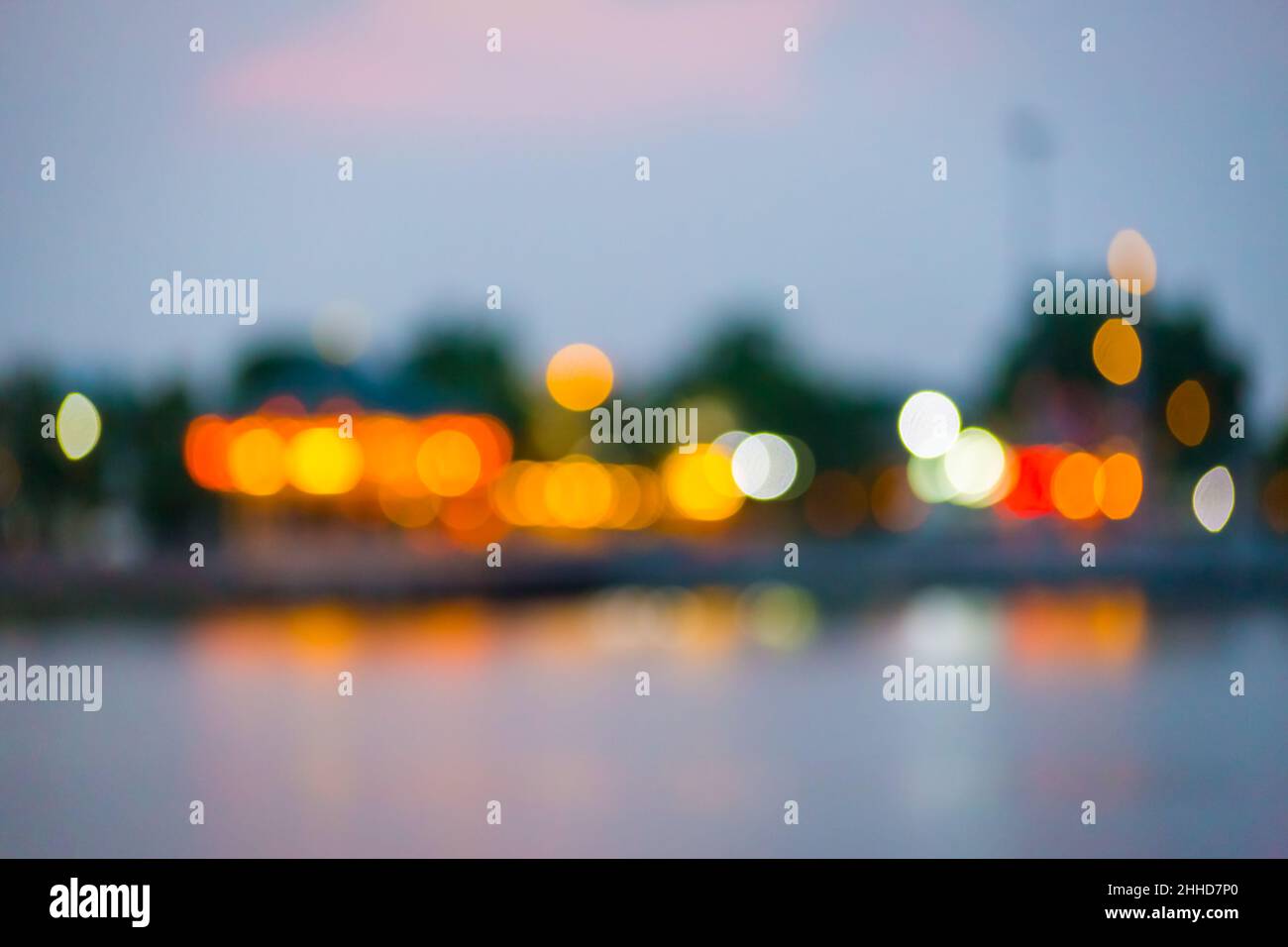 Beautiful blurred city lights with bokeh effect reflected on water ...