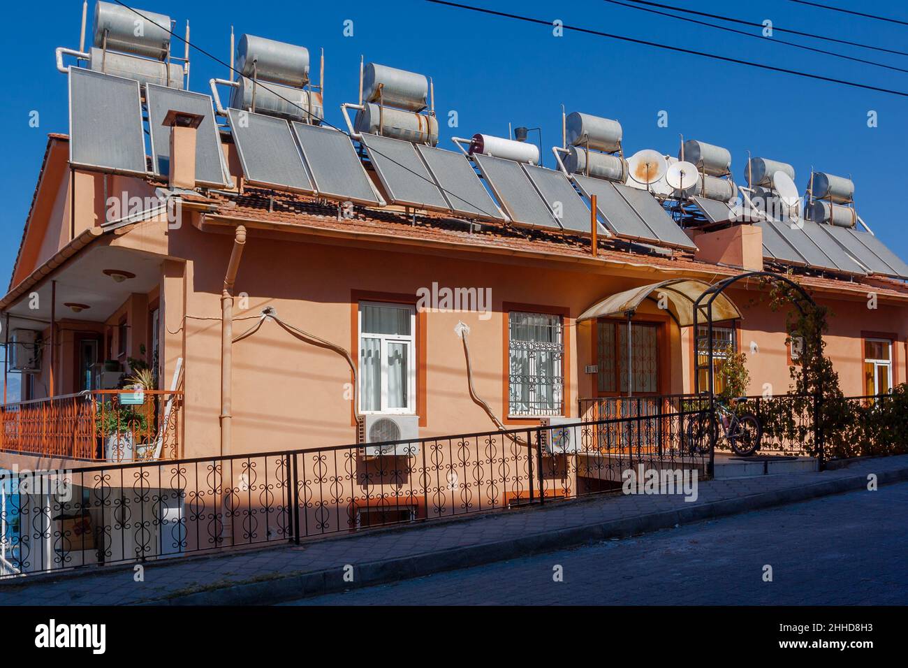 A lot of solar water heating systems on roof of house. A lot of large ...