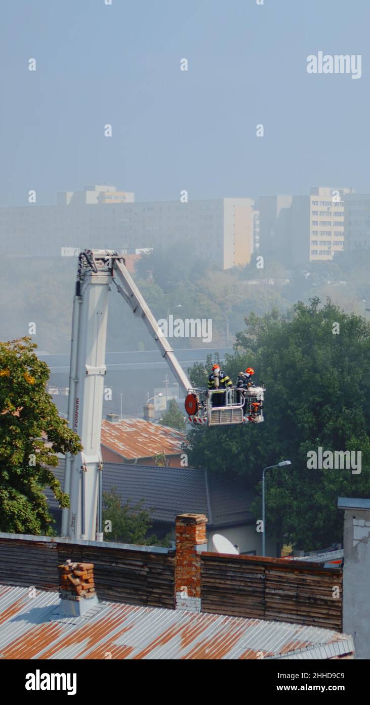 Men from fire department using firetruck to help firefighters on ...