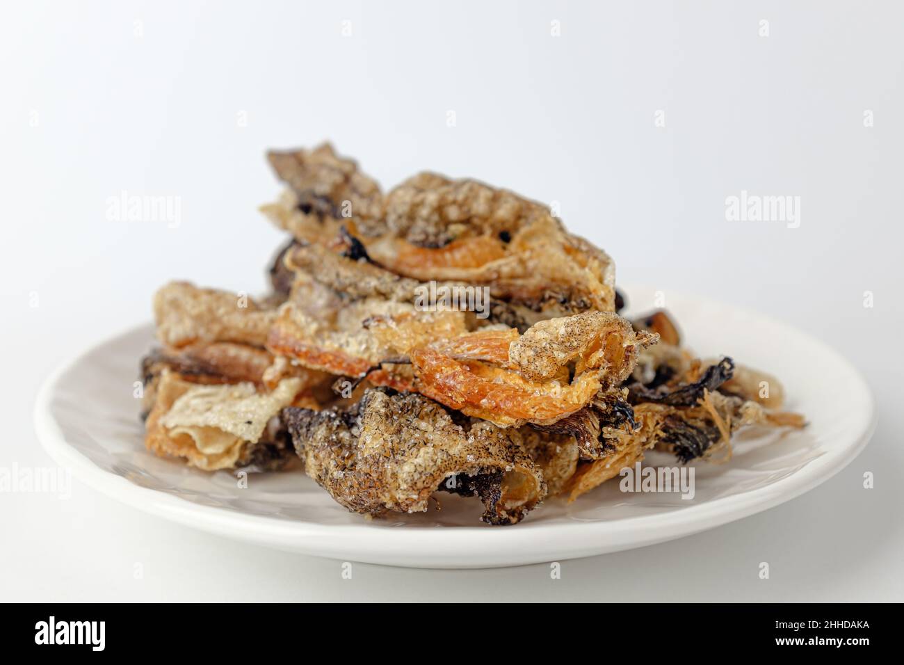 Deep-fried yellow pollack peel on a white background Stock Photo - Alamy