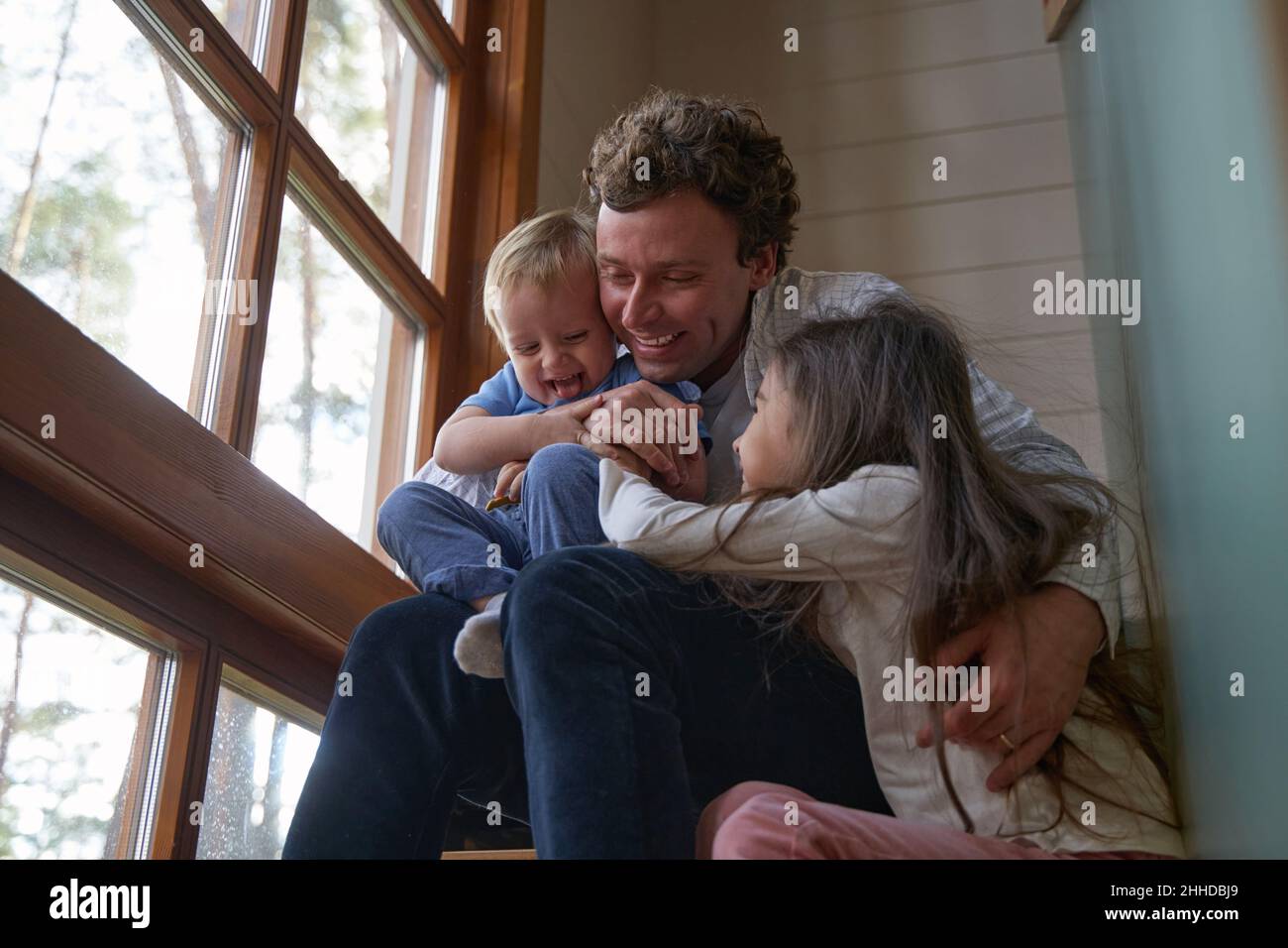 Happy male person being at home with kids Stock Photo - Alamy