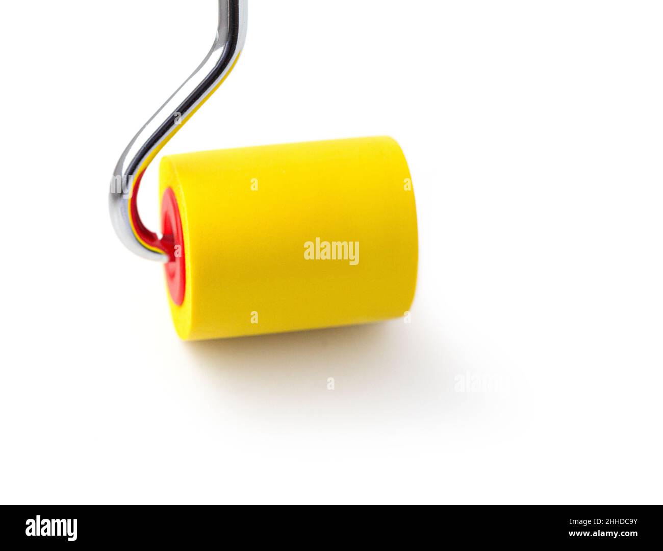 Yellow rubber paint roller on a white background Stock Photo - Alamy