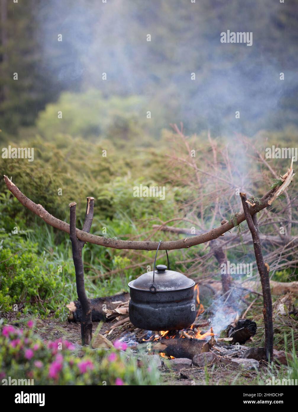 Cooking breakfast on fire in mountains. Camping season Stock Photo - Alamy
