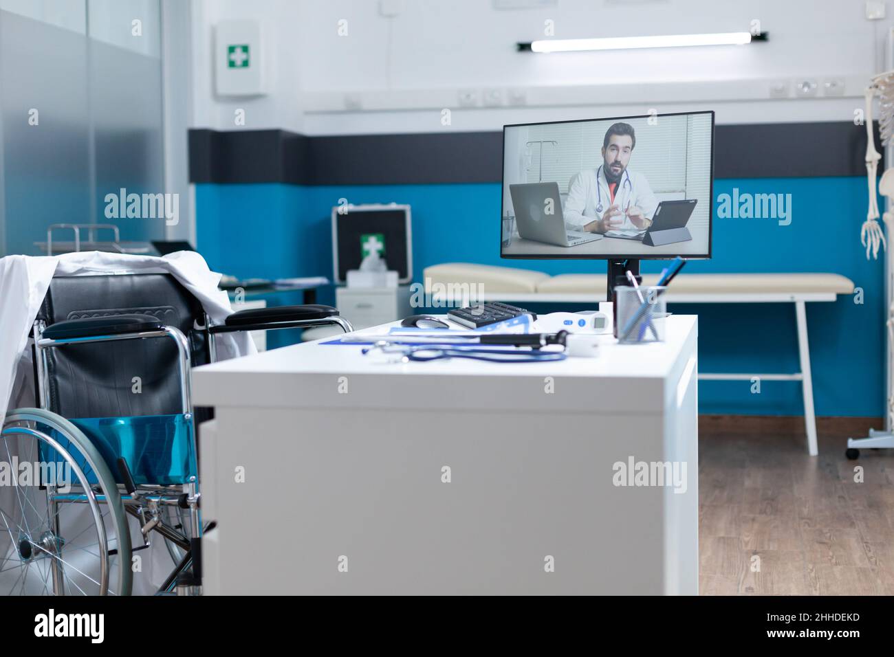 Modern empty doctors office having remore doctor talking during online ...