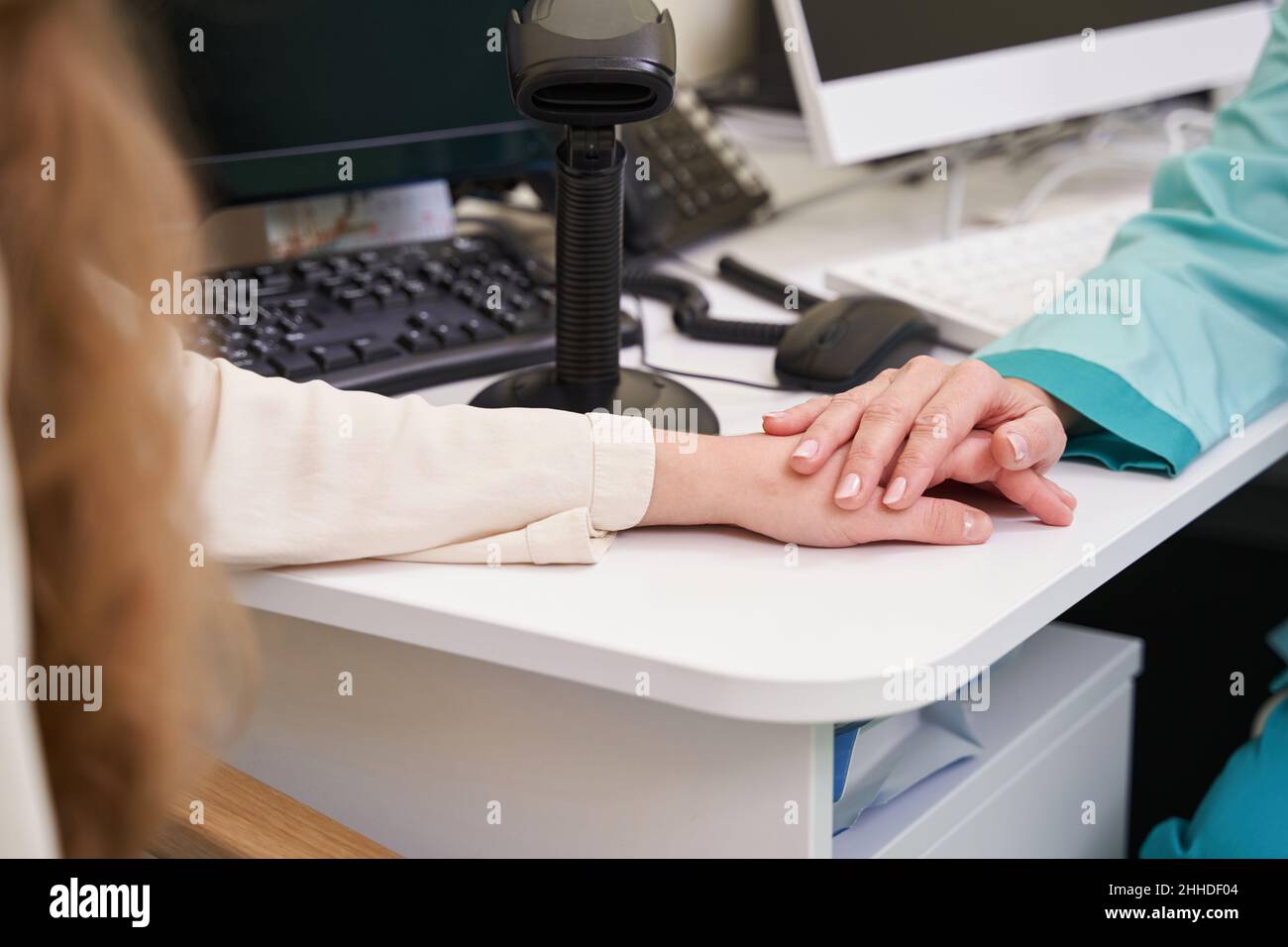 Female patient putting hand on the table Stock Photo - Alamy