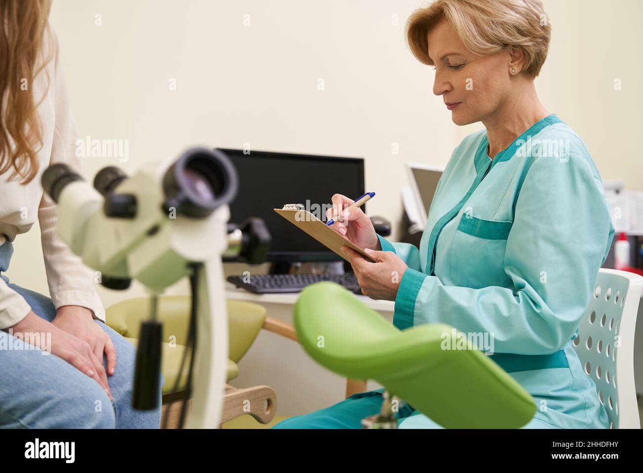 Profile photo of serious practitioner making notes Stock Photo - Alamy