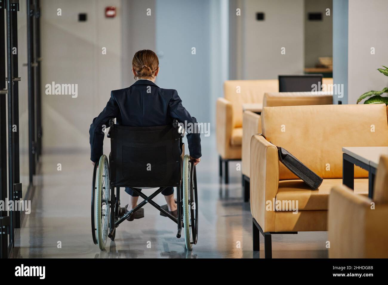 Full length portrait of successful businesswoman using wheelchair in ...