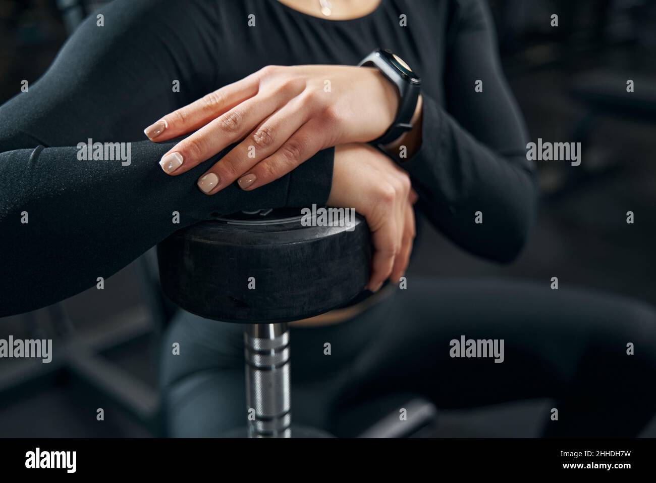 Caucasian female athlete leaning on hand weight Stock Photo - Alamy