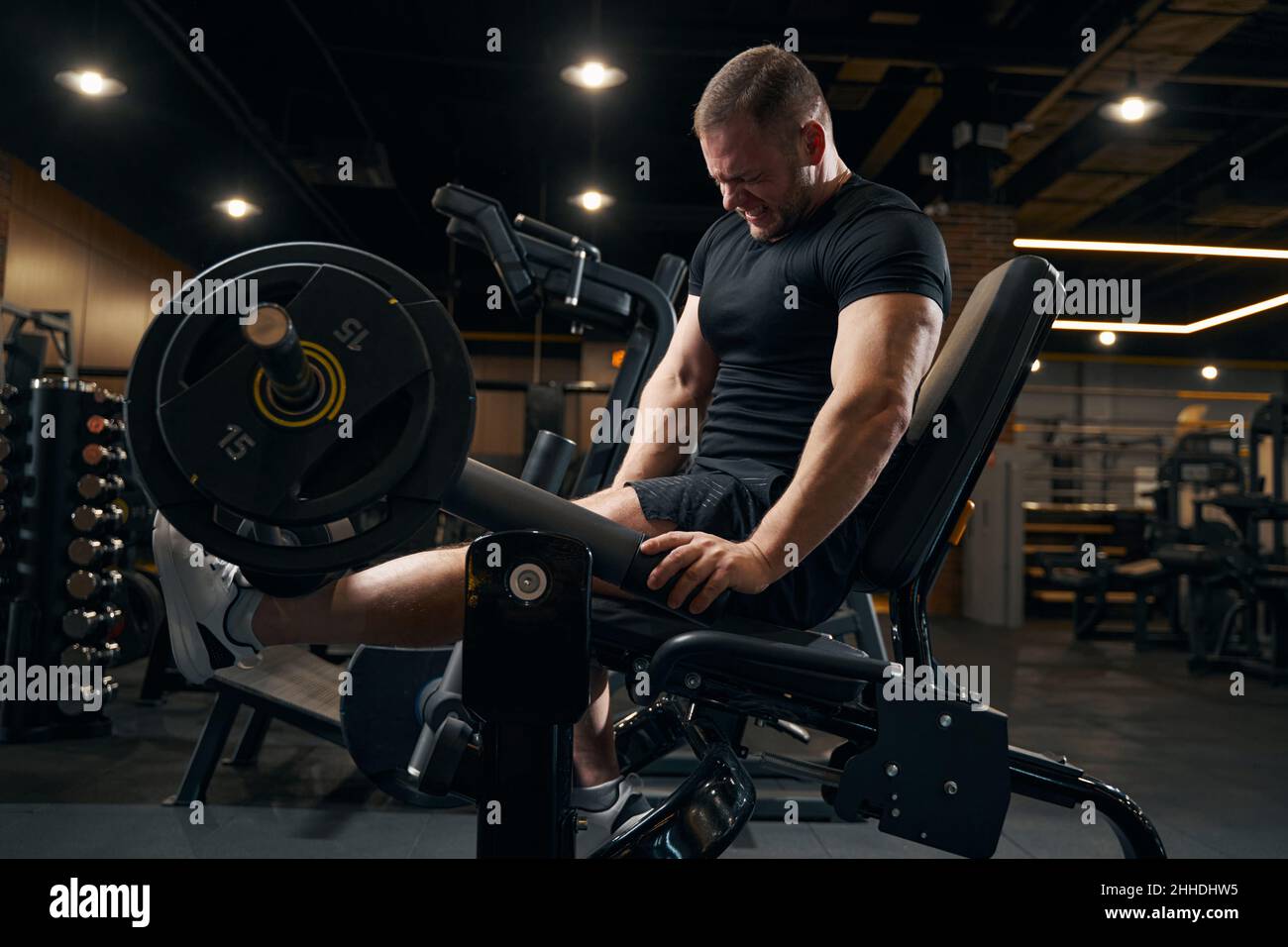 Strong weightlifter working out on exercise equipment Stock Photo - Alamy