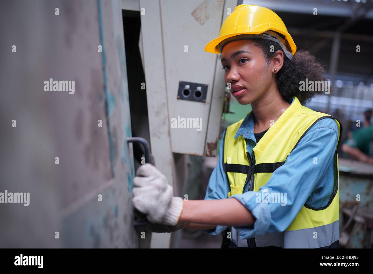 Female apprentice in metal working factory, Portrait of working female ...