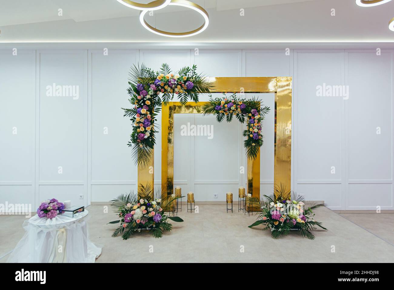The wedding arch in the restaurant is decorated with fresh flowers and ...