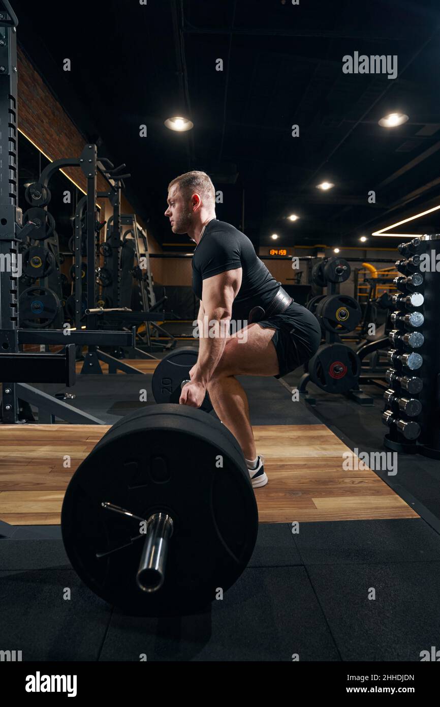 Professional male weightlifter performing deadlift at gym Stock Photo ...