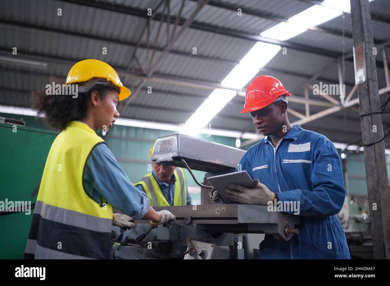 Female apprentice in metal working factory, Portrait of working female ...