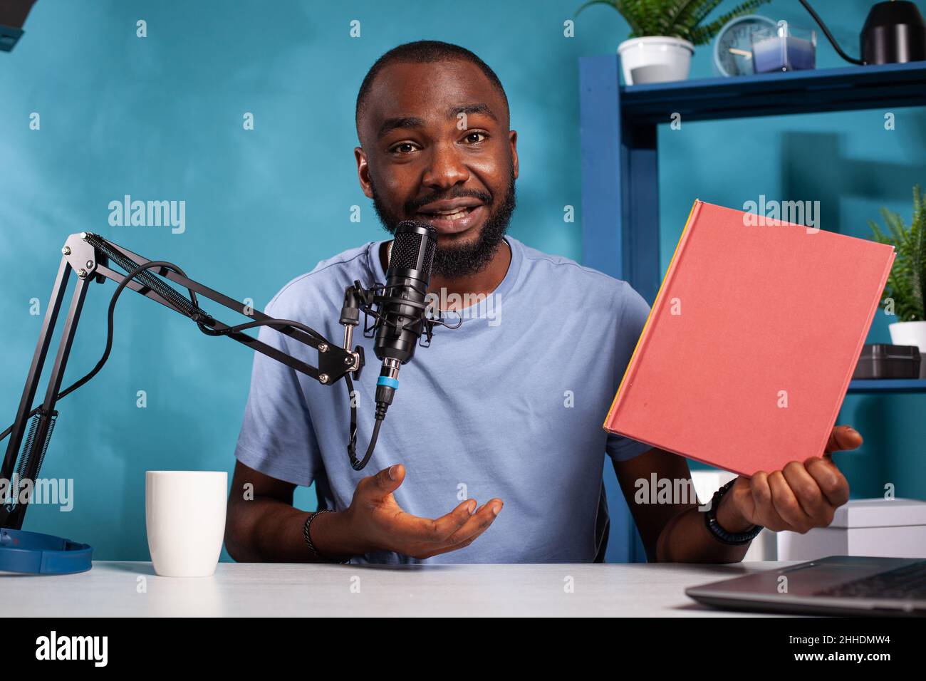 Portrait of vlogger with audio microphone recording podcast talking ...