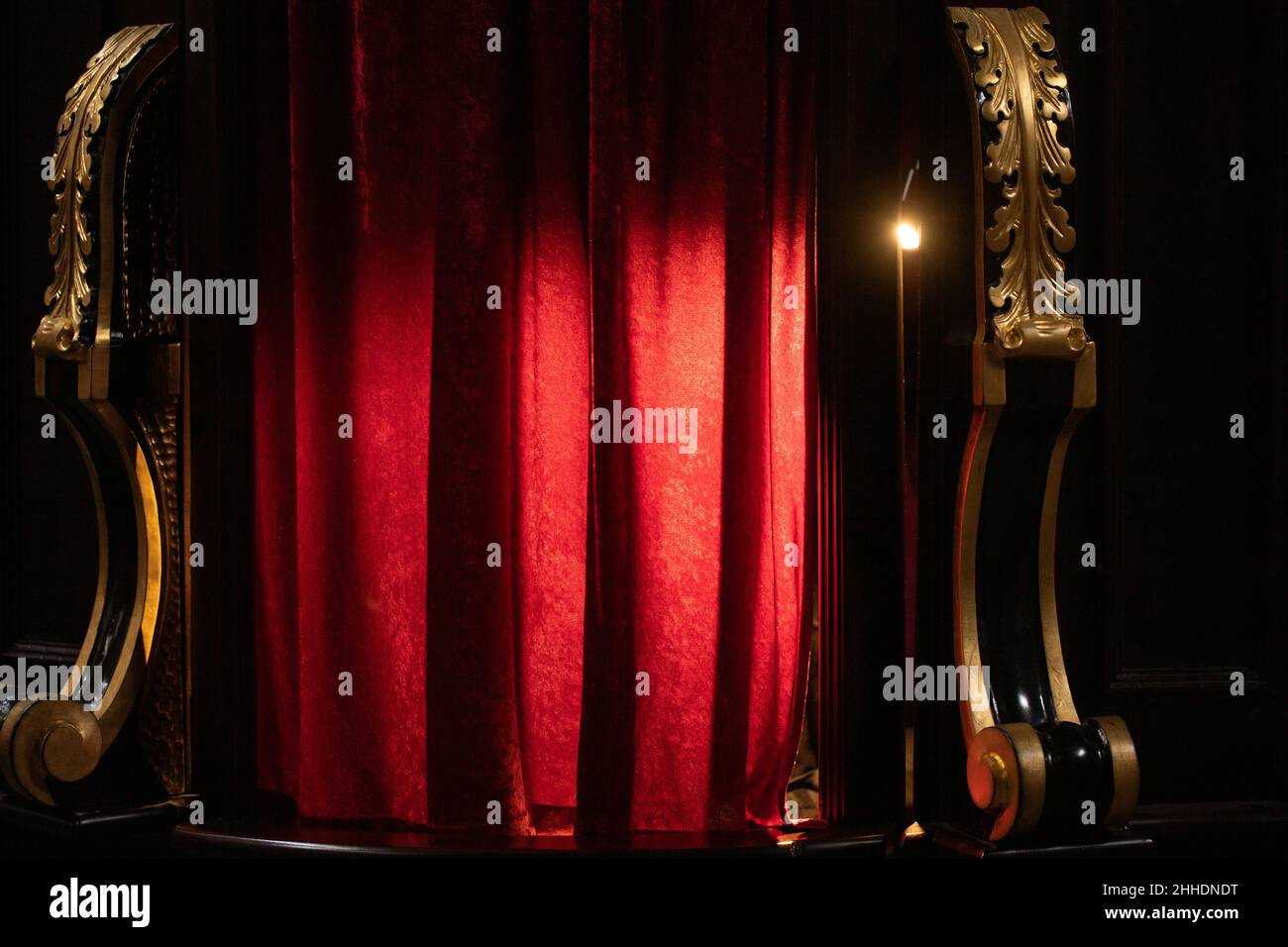 Poznan, Poland - Confessional lit up in red, priest inside, baroque ...