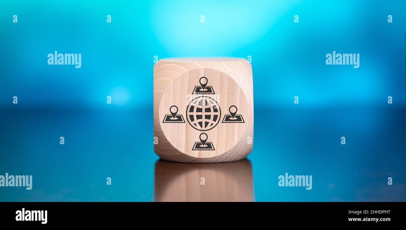 Wooden block with symbol of globalization concept on blue background ...