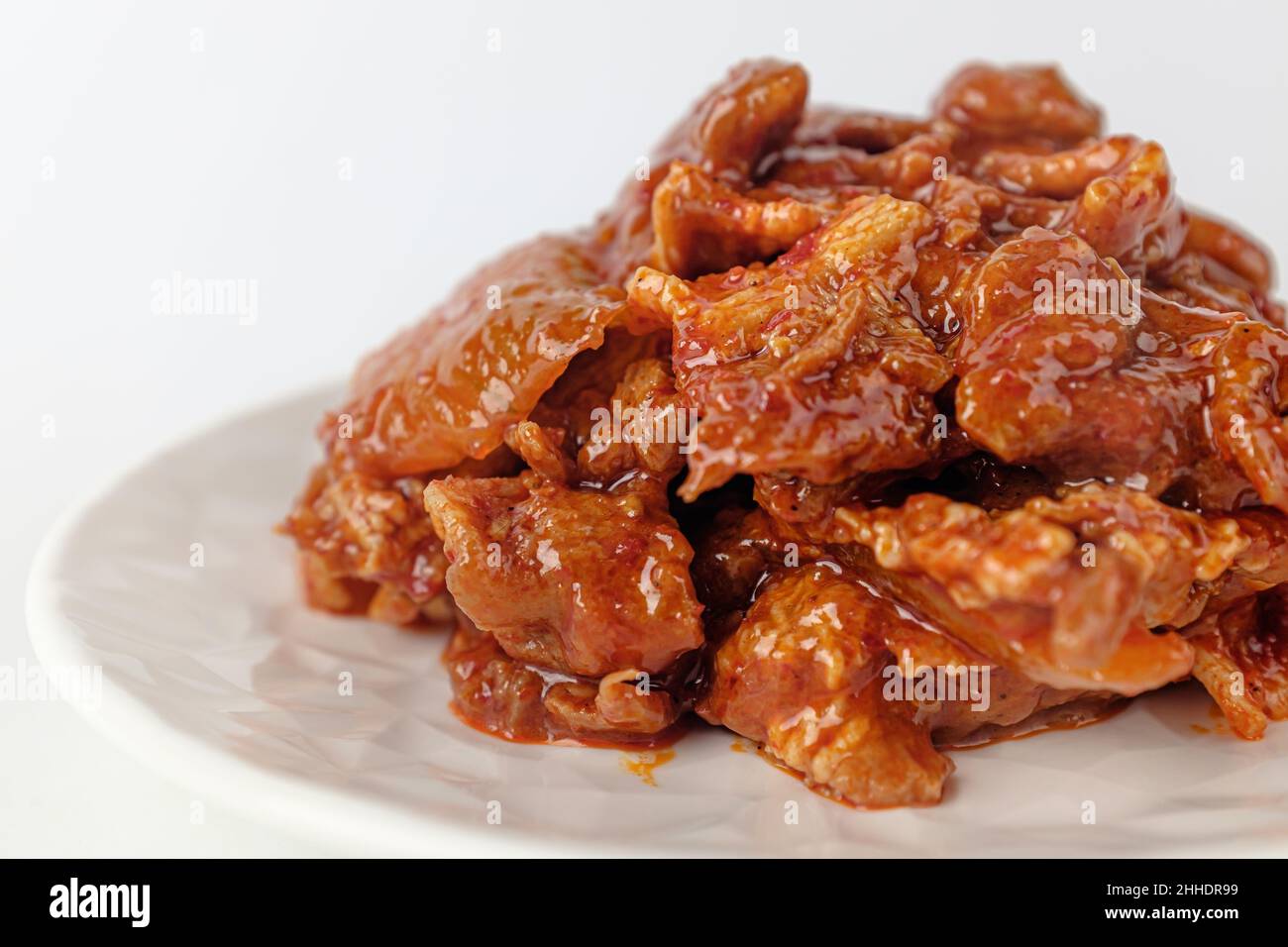 stir-fried meat on a white background Stock Photo - Alamy