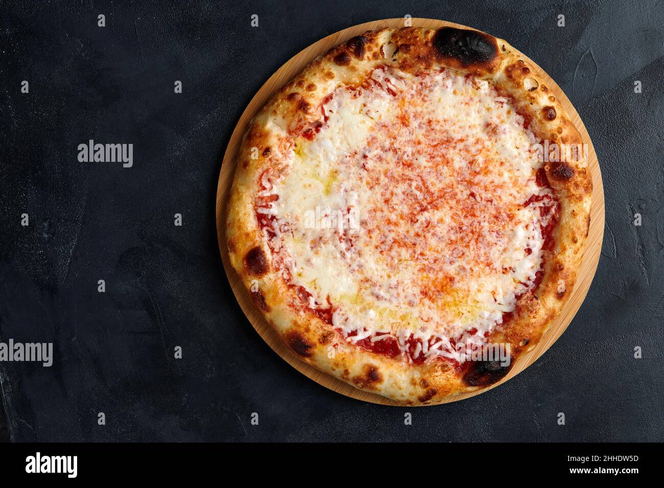 Pizza Margherita on dark stone background, top view. Flyer and poster ...