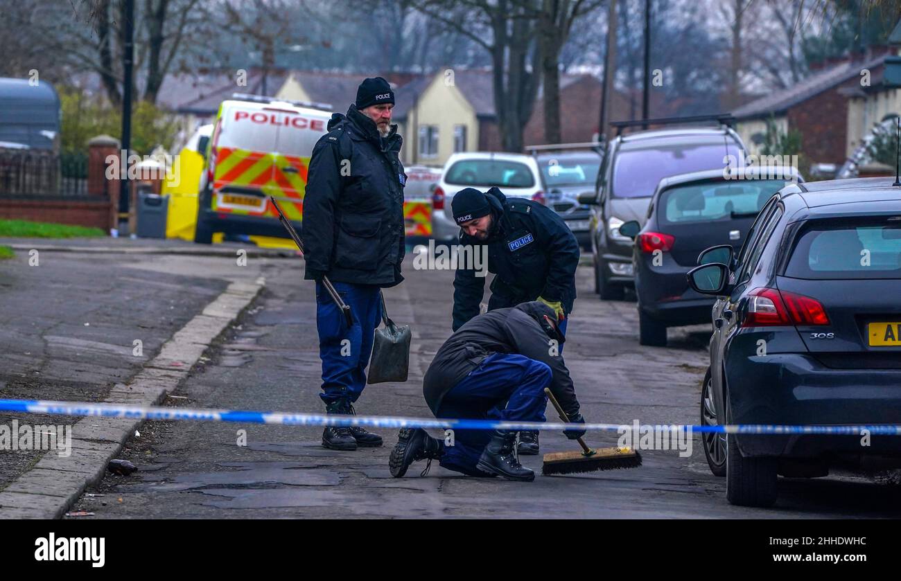 Greater Manchester Police officers searching for evidence at the scene ...