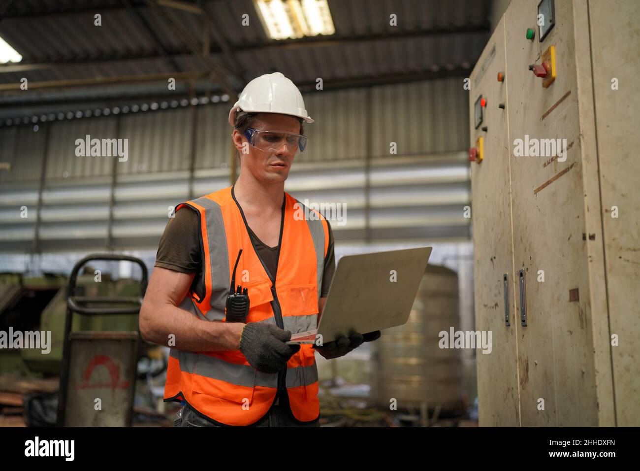 Professional engineer metalworker operating CNC milling machine center ...