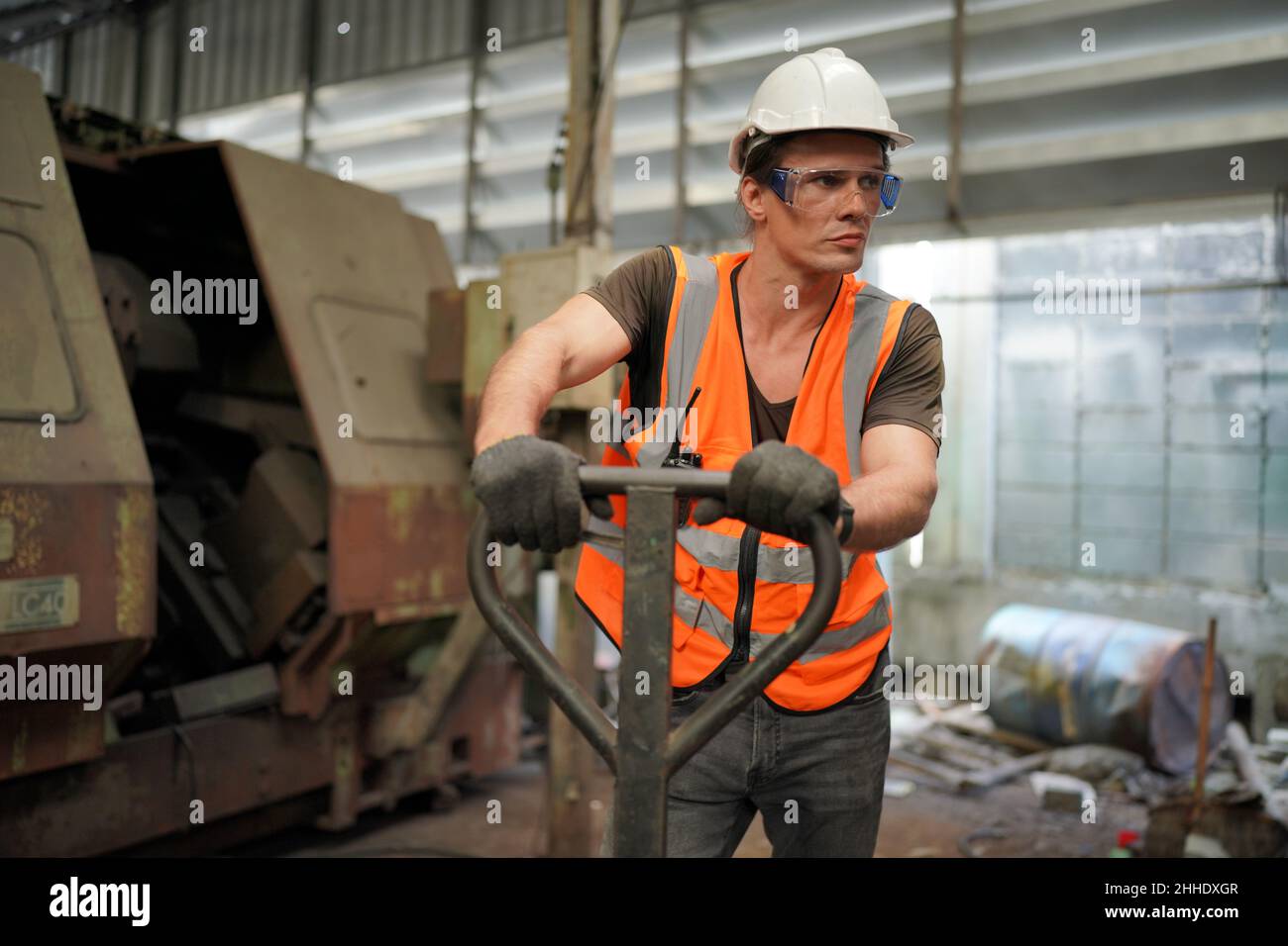 Professional engineer metalworker operating CNC milling machine center ...