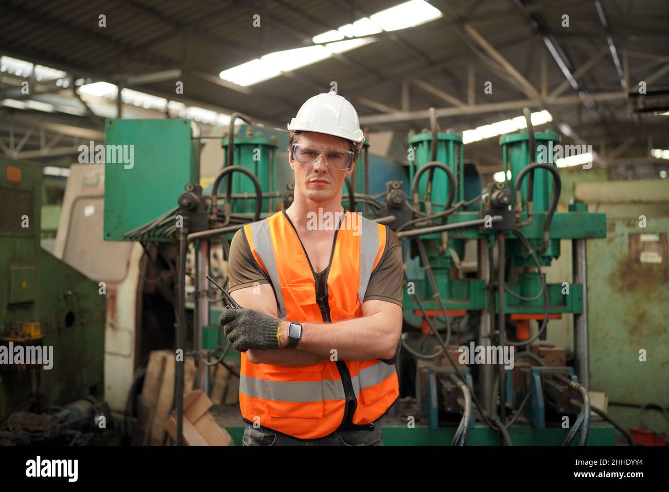 Professional engineer metalworker operating CNC milling machine center ...