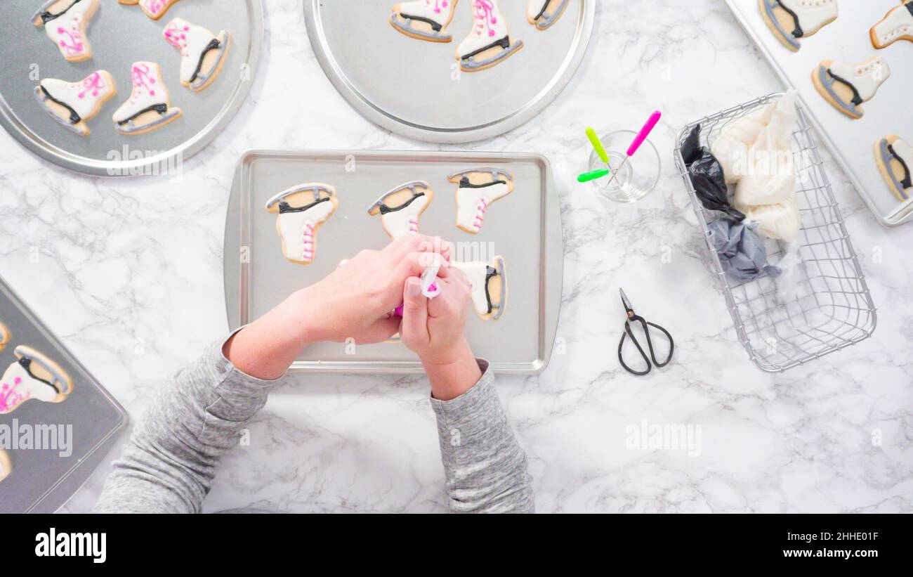 Flat lay. Icing figure skate shaped sugar cookies with royal icing ...