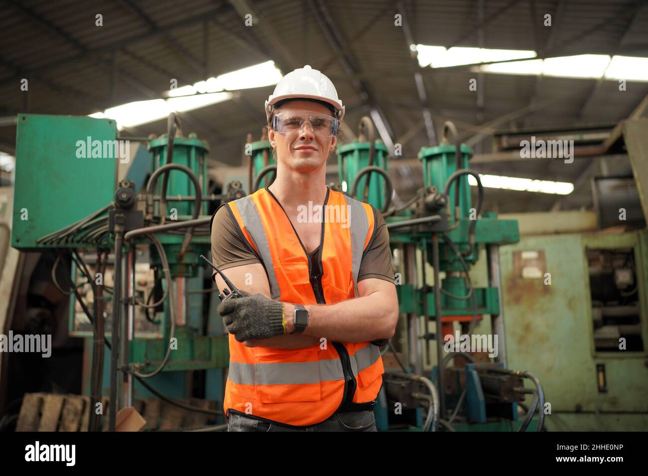 Professional engineer metalworker operating CNC milling machine center ...