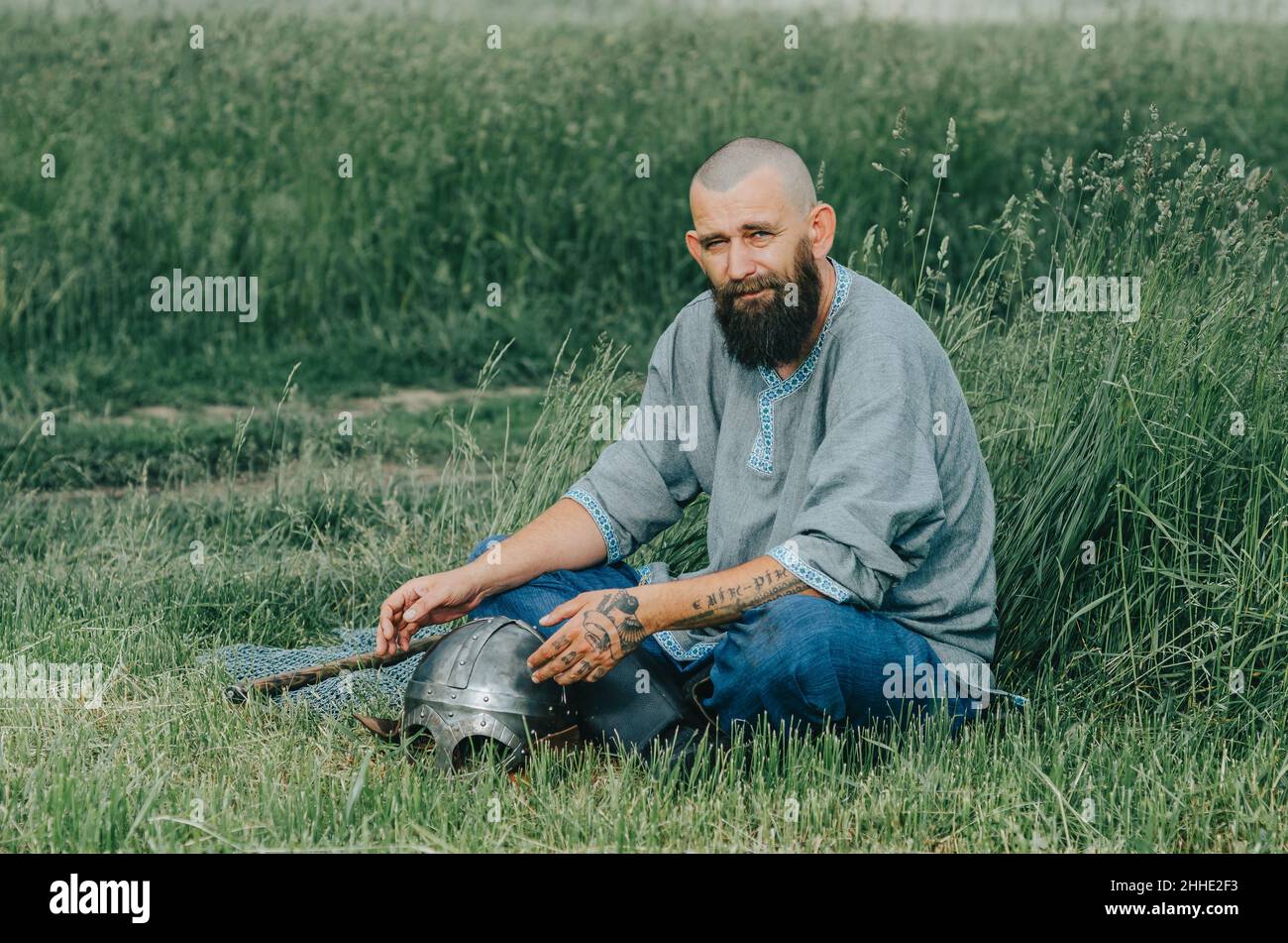 Portrait of man in medieval clothes on summer field. Viking armor ...