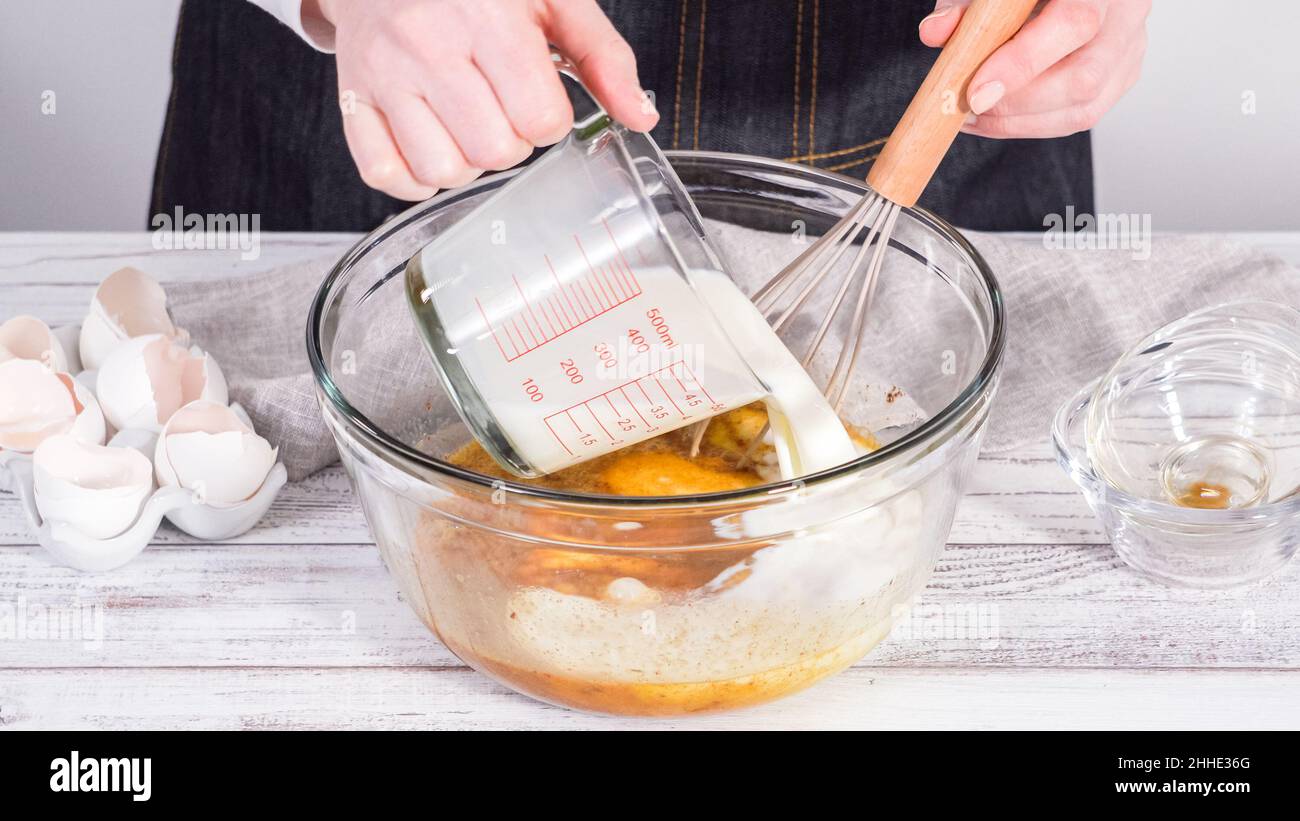 Step by step. Mixing ingredients in a large glass mixing bowl to ...