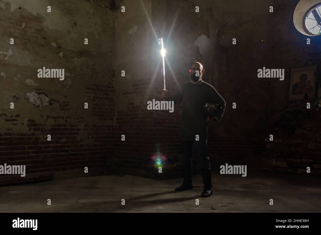 Fire sword in hands of Viking in mysterious castle. Mystical photo ...