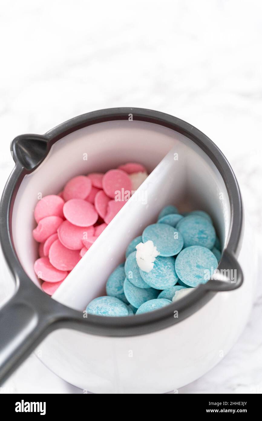 Melting chocolate melts in a candy melting pot to prepare mermaid tails ...