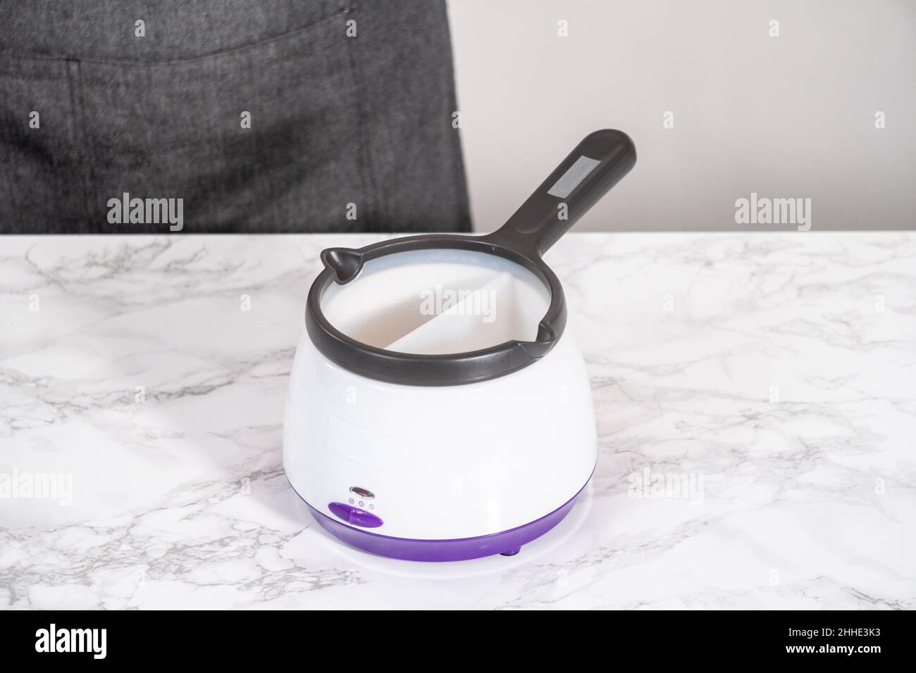 Melting chocolate melts in a candy melting pot to prepare mermaid tails ...