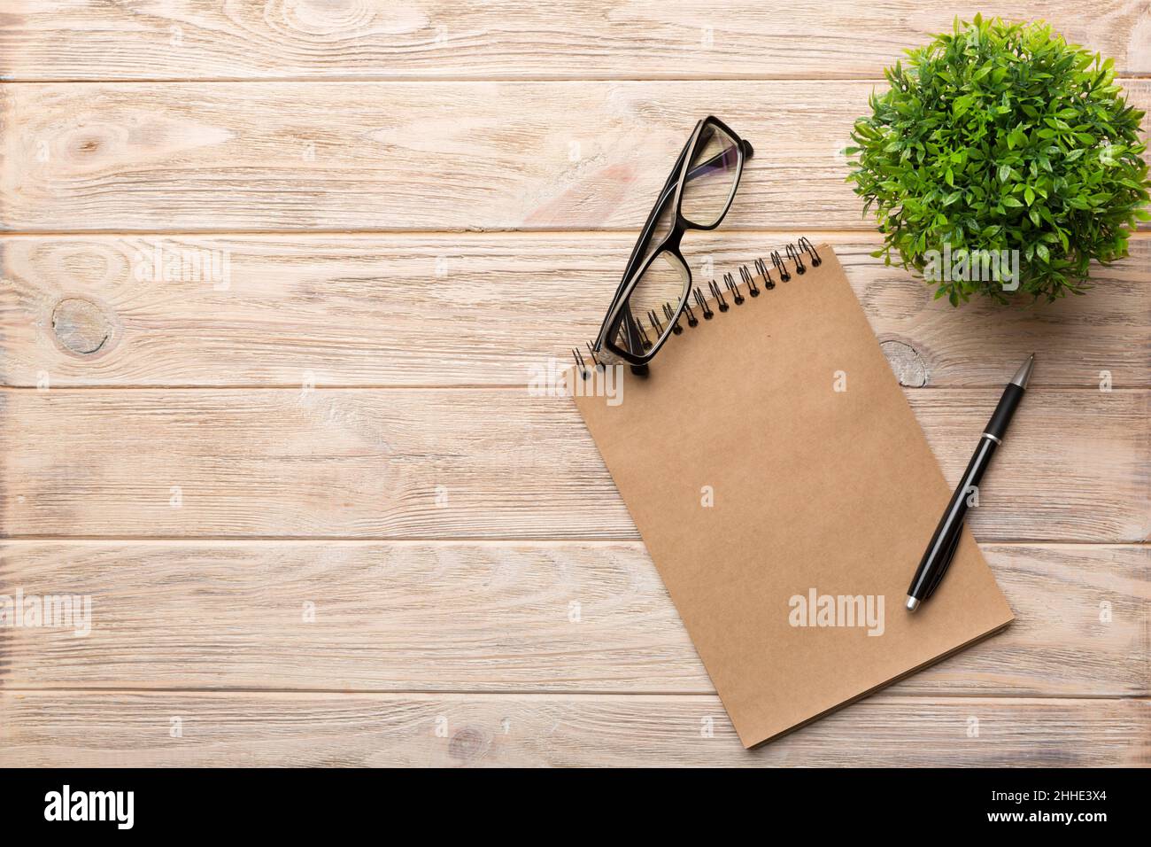 Modern office desk table with notebook and other supplies with green ...