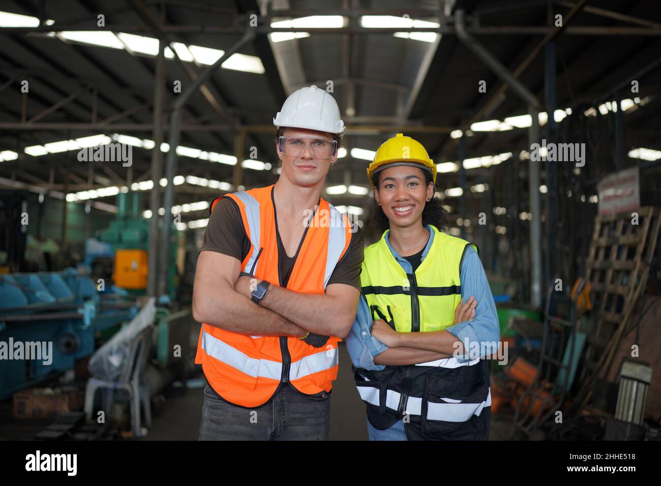 Portrait of male and female engineers working in the metalwork industry ...