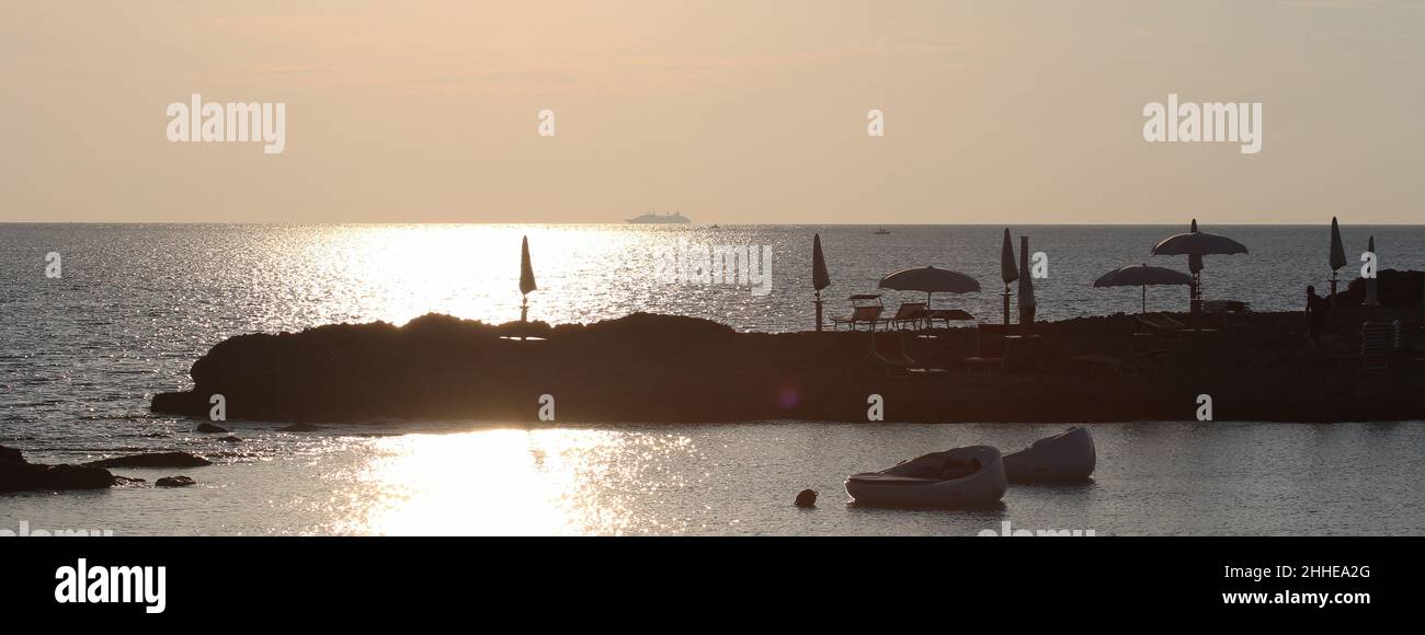 Horizontal banner or header with sunset in the beautiful bay with rock ...