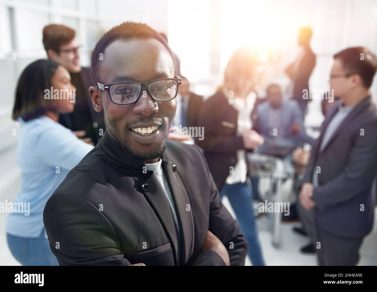 close up. smiling young businessman standing in the office Stock Photo ...