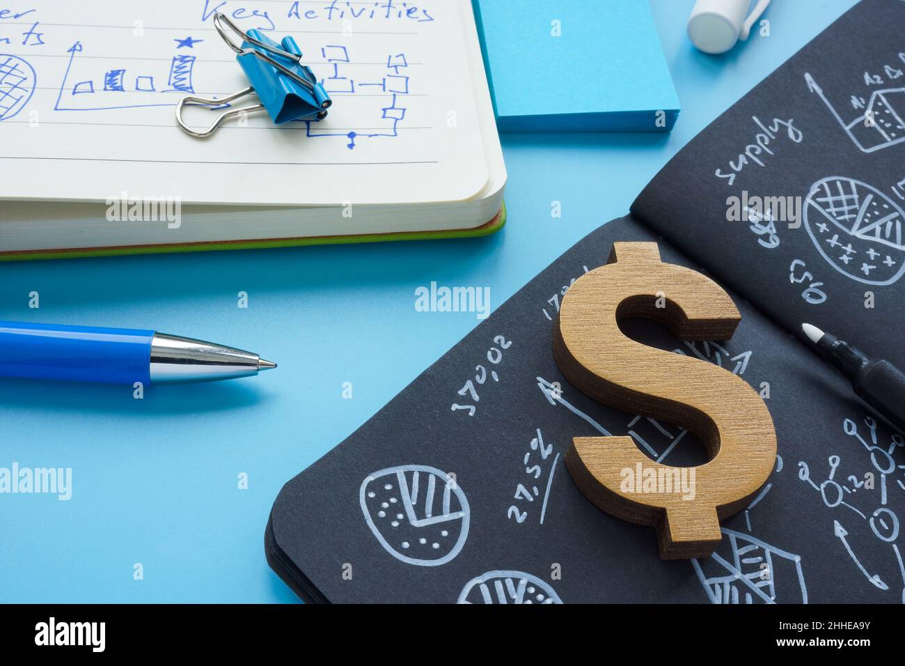 Open notebooks with notes and a dollar sign as a symbol of profit Stock ...