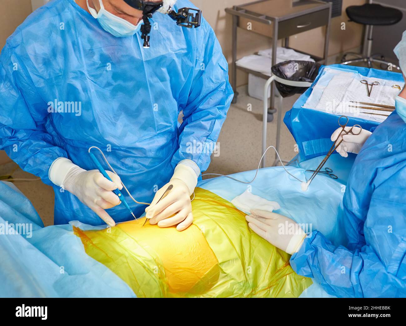 Medical team of surgeons in hospital doing minimal invasive surgical ...