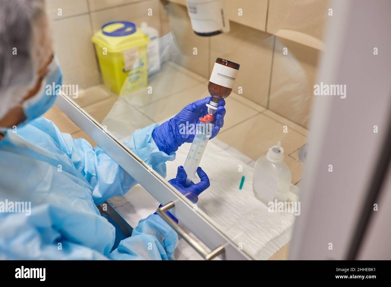 Anesthesiologist Doctors hand inject syringe into mixing normal saline ...