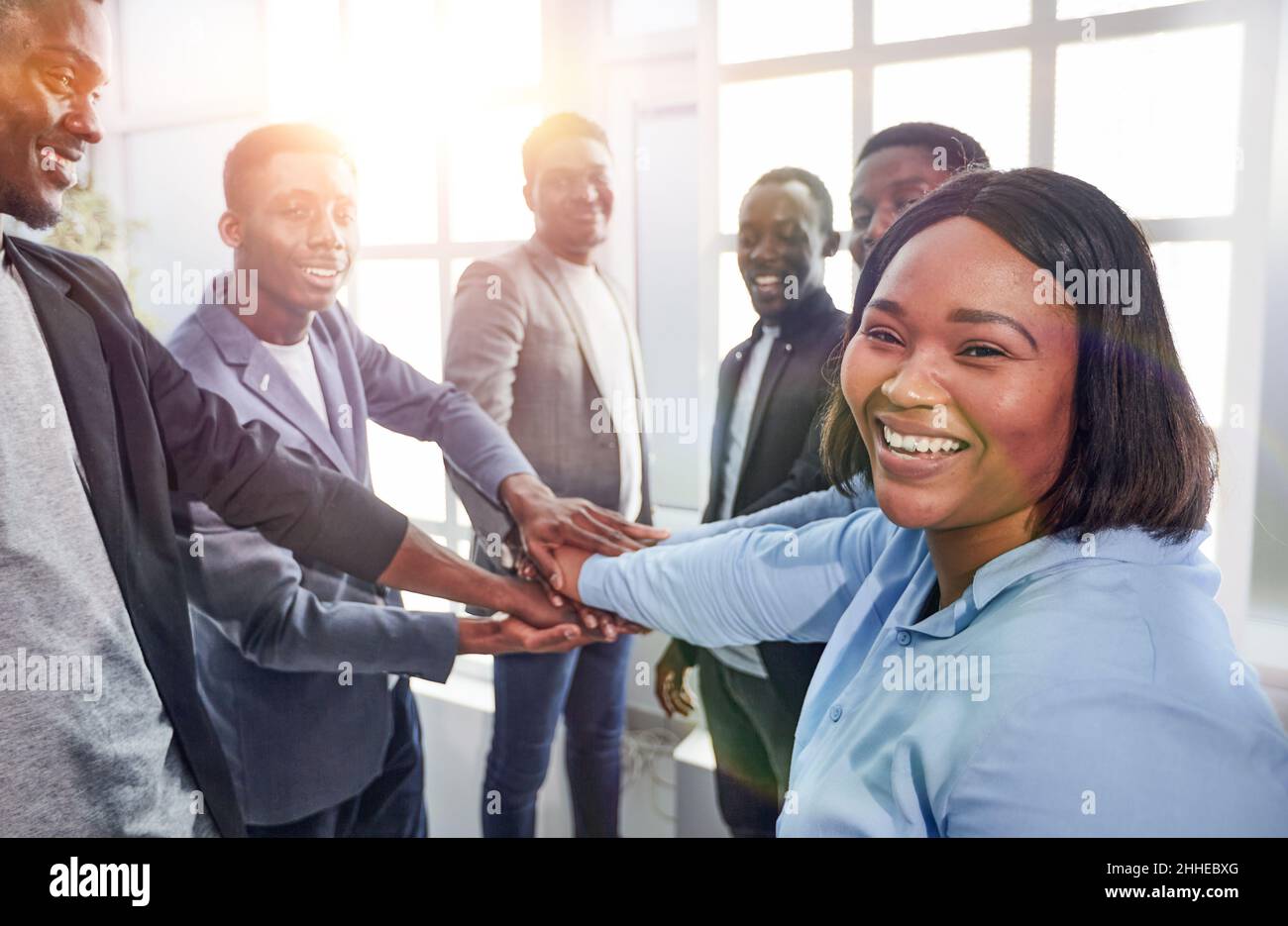 young business woman and her colleagues are showing their unity Stock ...