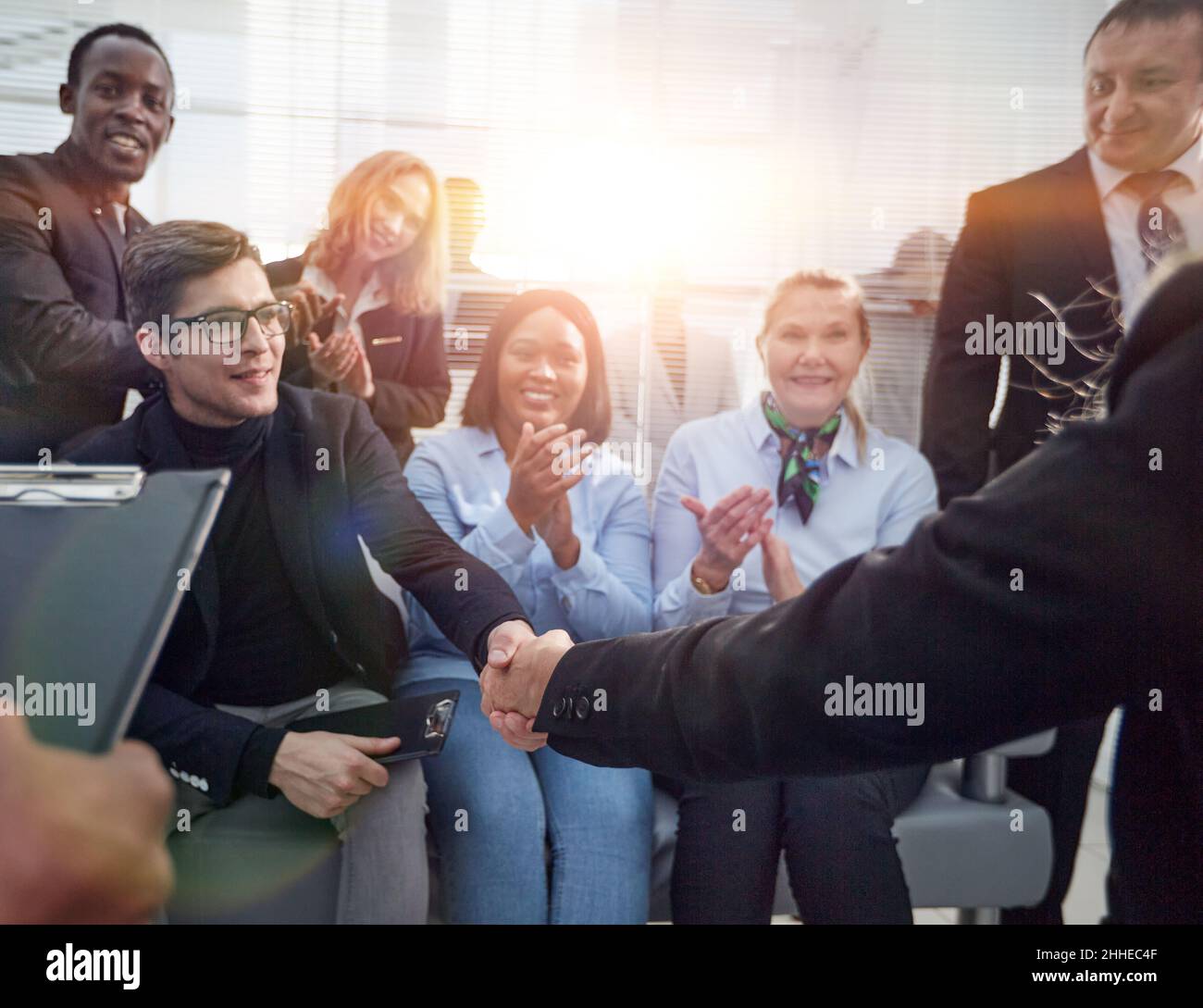 employees congratulating their colleague at a work meeting Stock Photo ...